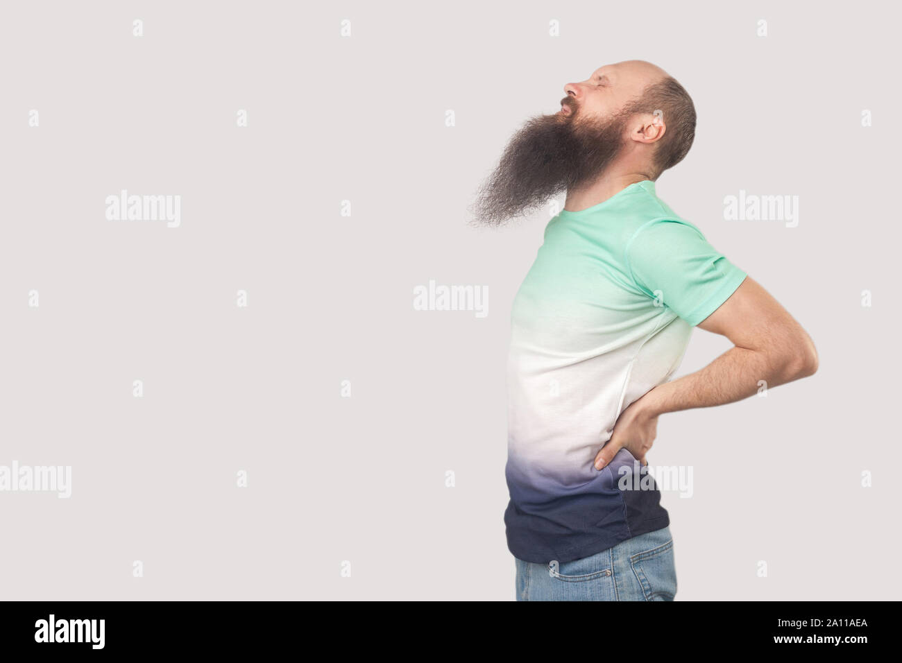 Back, spinal or kidney pain. Profile side view portrait of middle aged ...