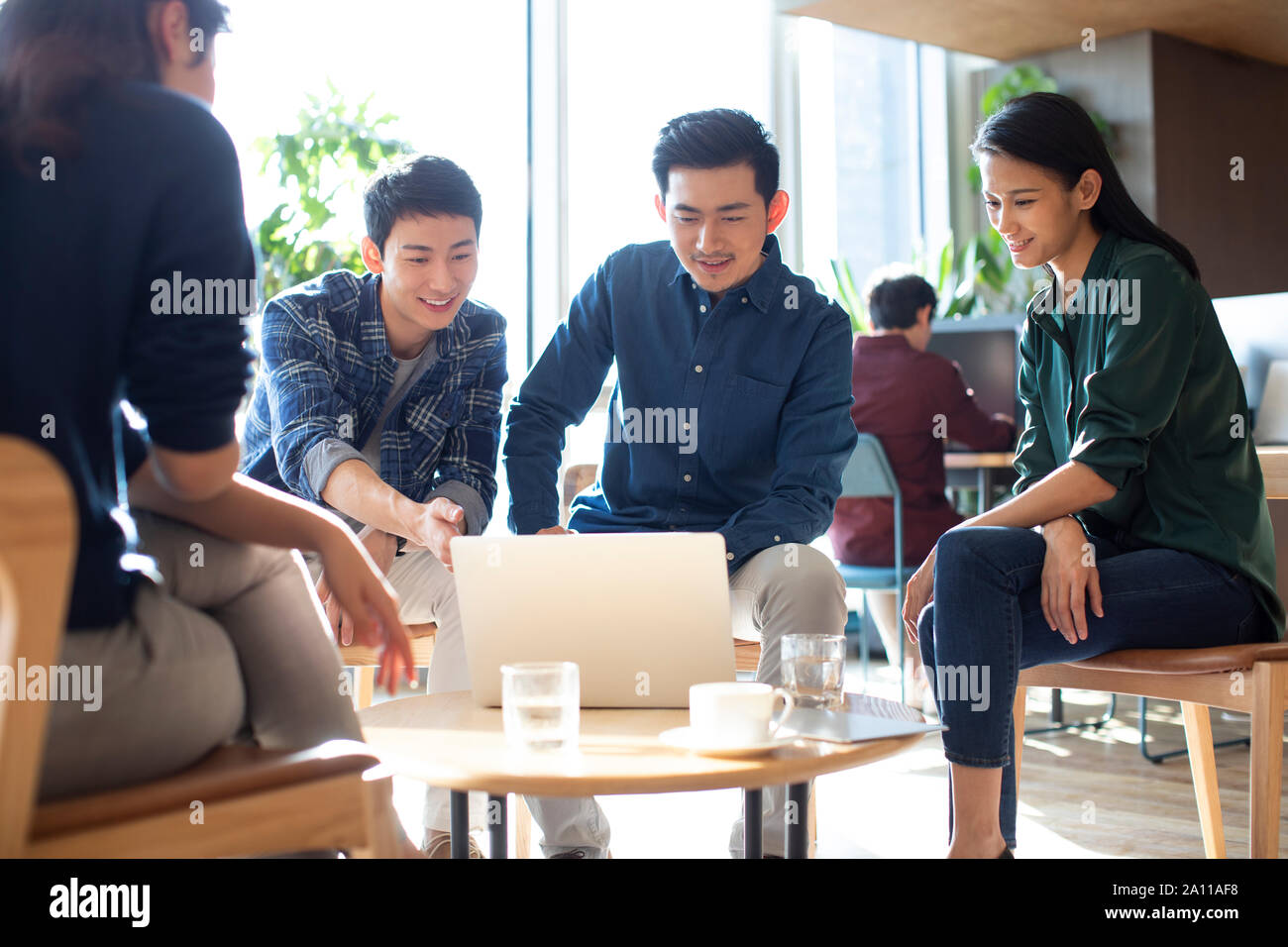 Young college students talking with teacher Stock Photo - Alamy
