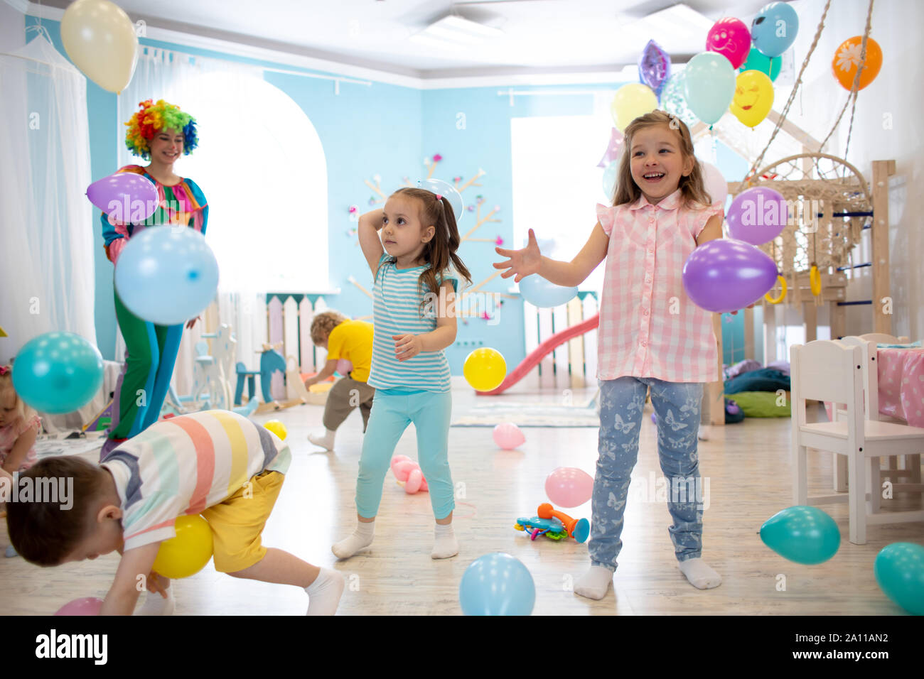Preschool kids dancing and playing on birthday party in children club ...