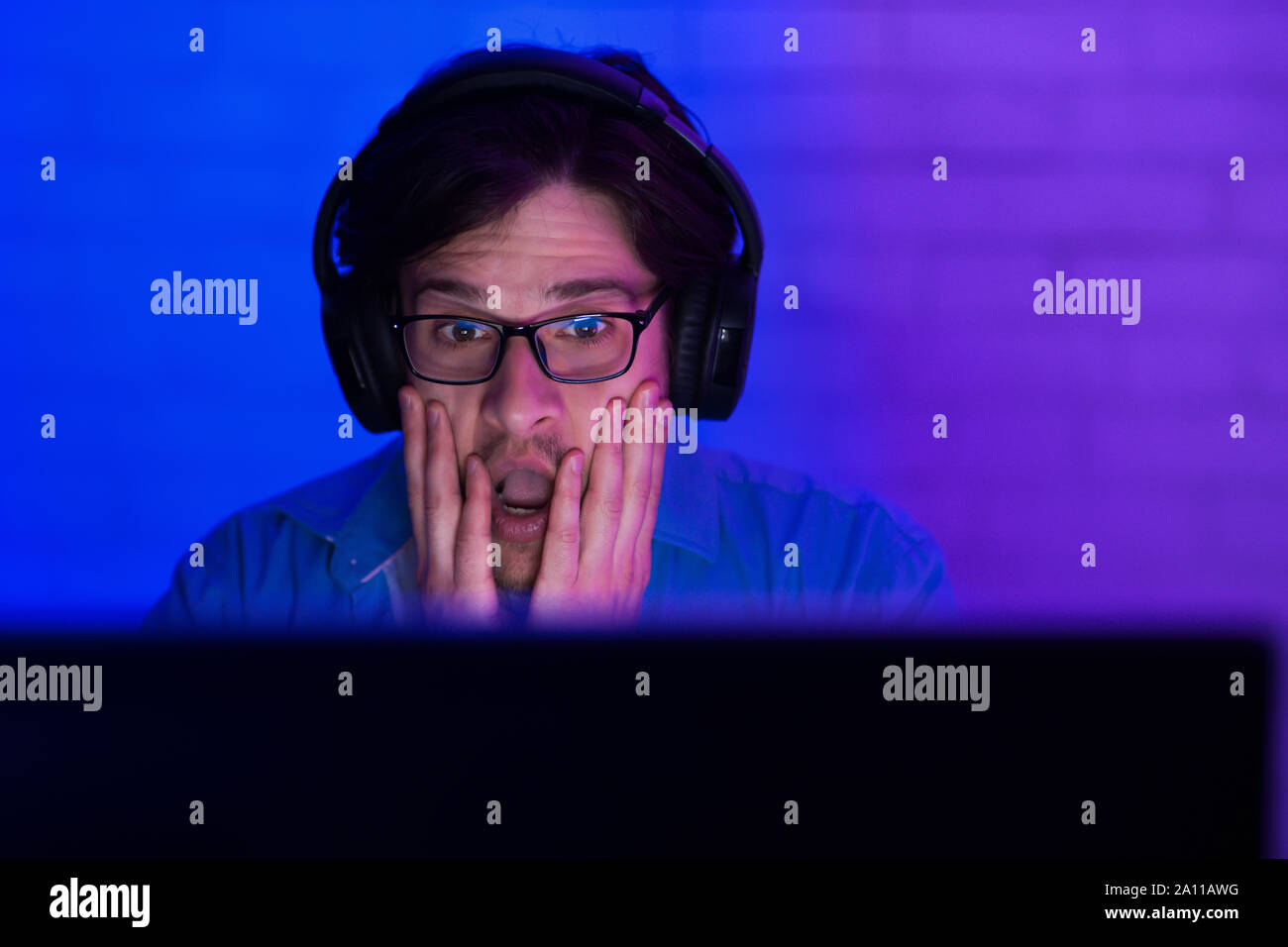 Gamer concept. Terrified gamer playing games on computer Stock Photo ...