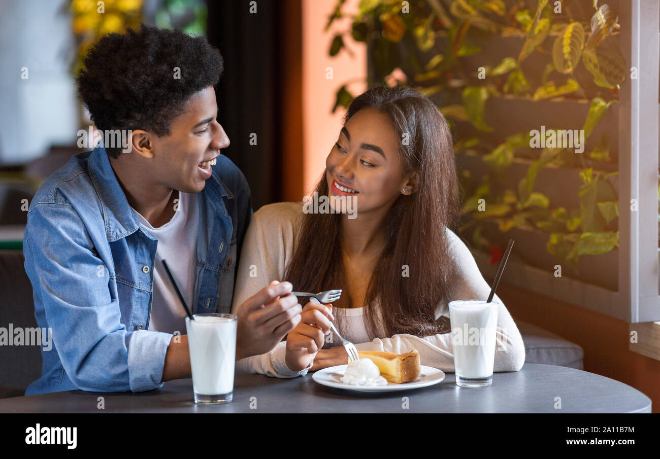 Young happy couple having date in cafe Stock Photo - Alamy