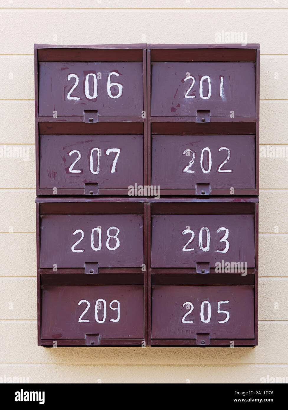 Close-up of Wall-mounted community letter boxes, numbered from 201 to ...