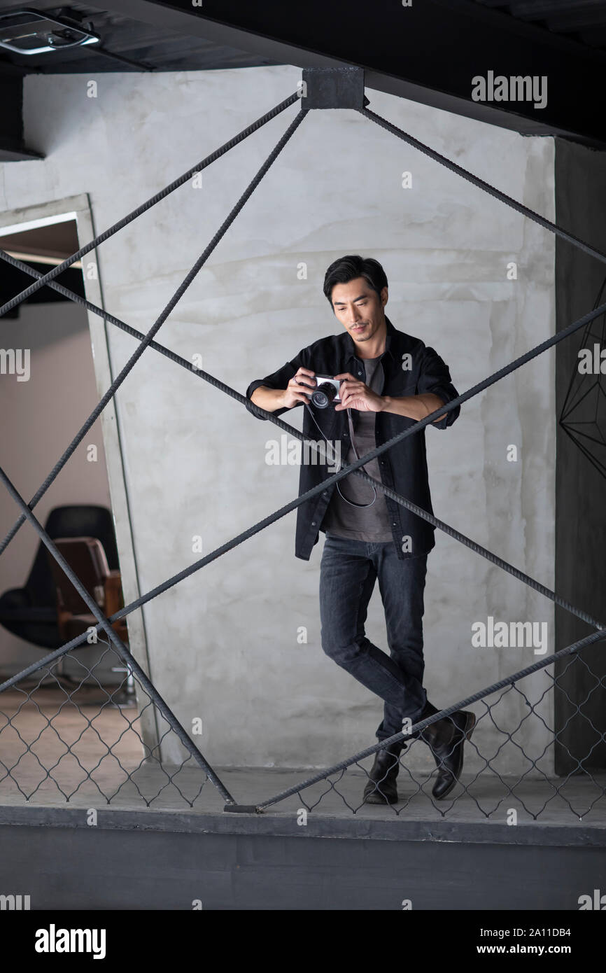 Photographer using camera in studio Stock Photo - Alamy