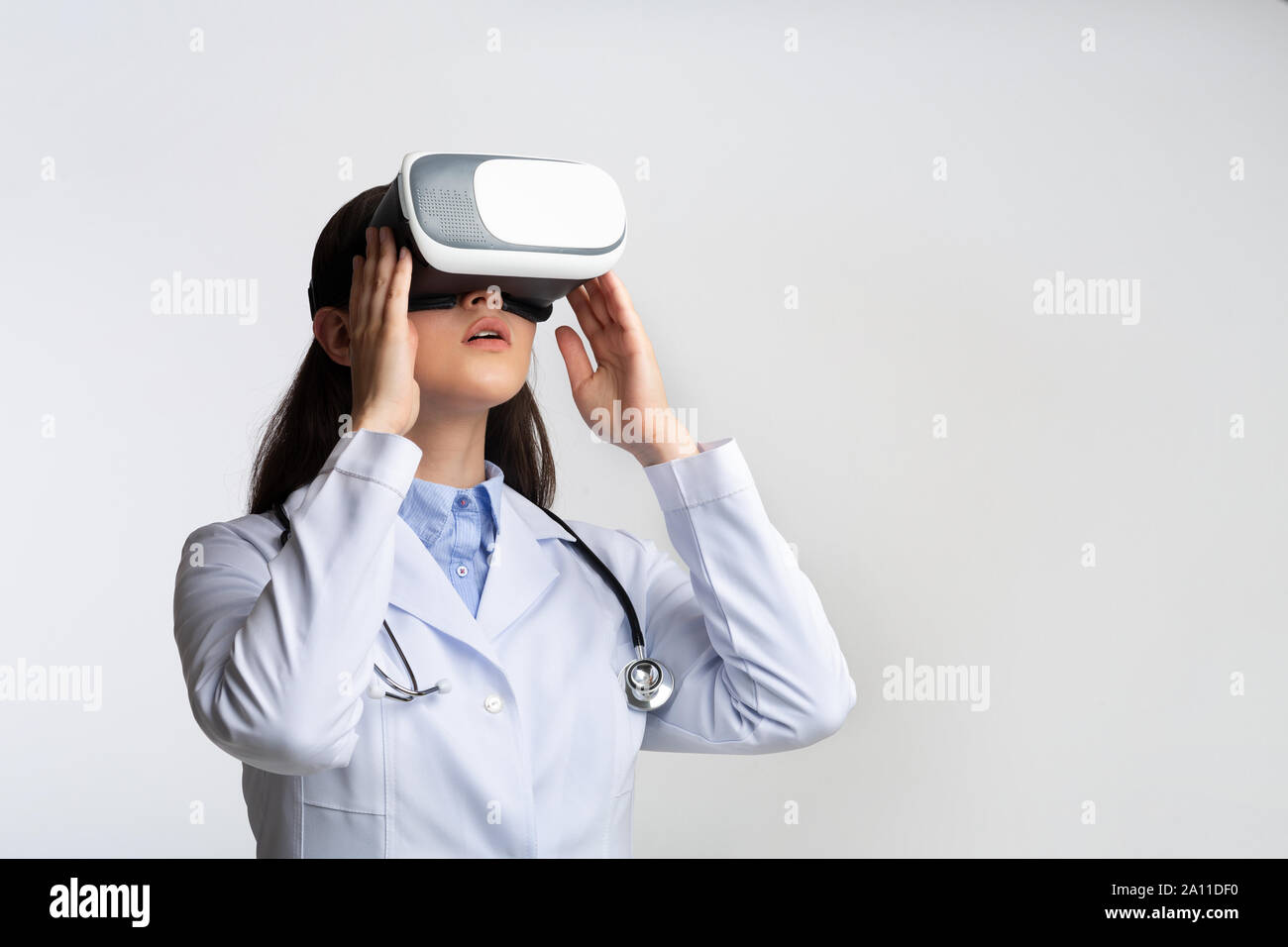Doctor Using Virtual Reality Headset Over White Studio Background Stock ...
