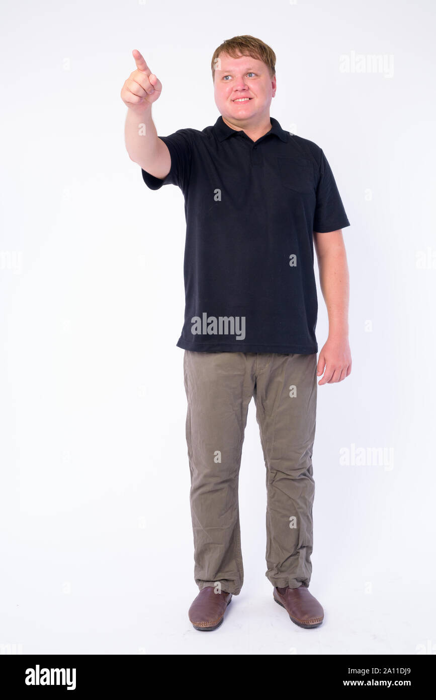 Full body shot of happy overweight man pointing finger Stock Photo - Alamy