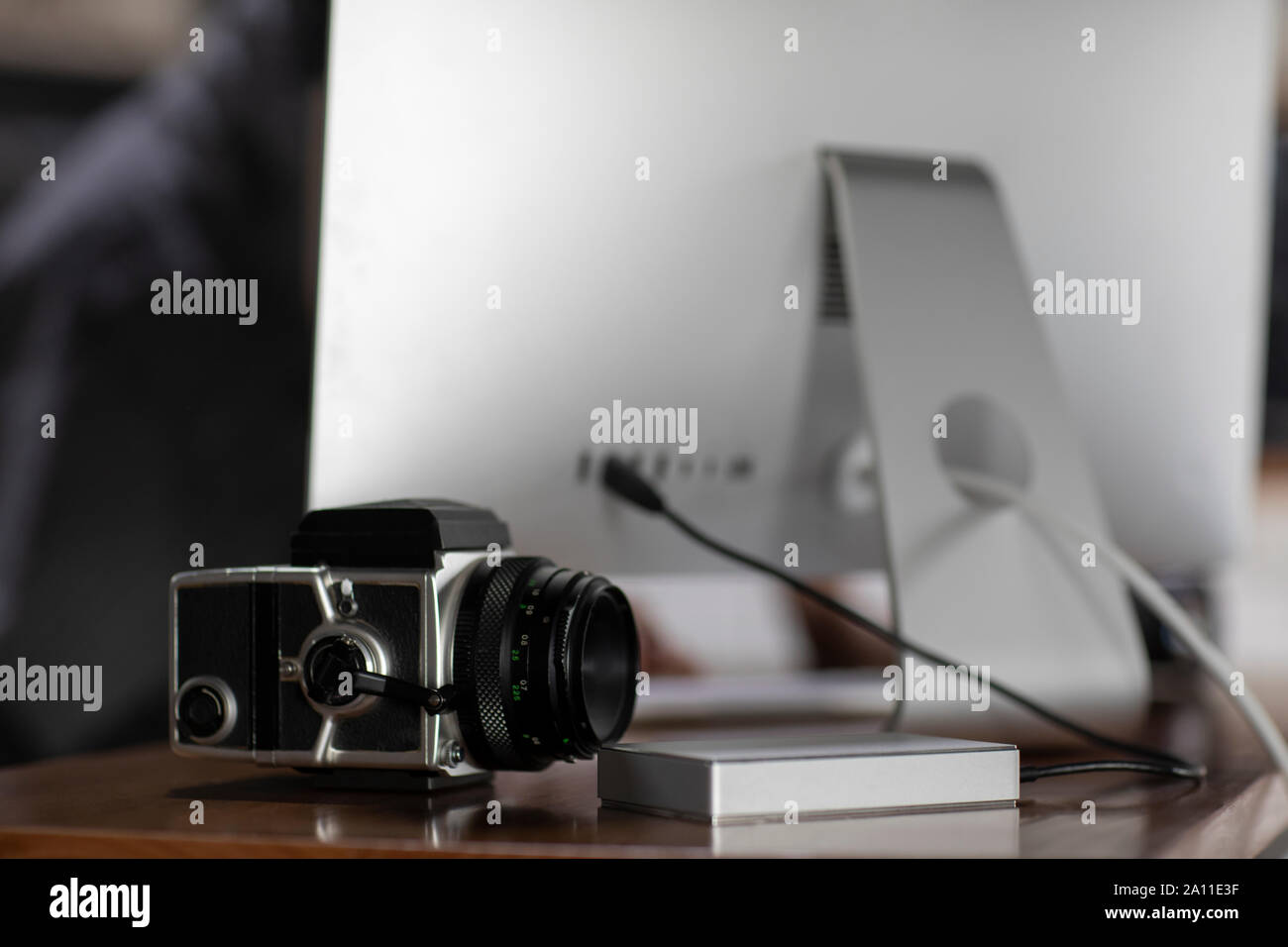 Camera and computer on desk Stock Photo - Alamy
