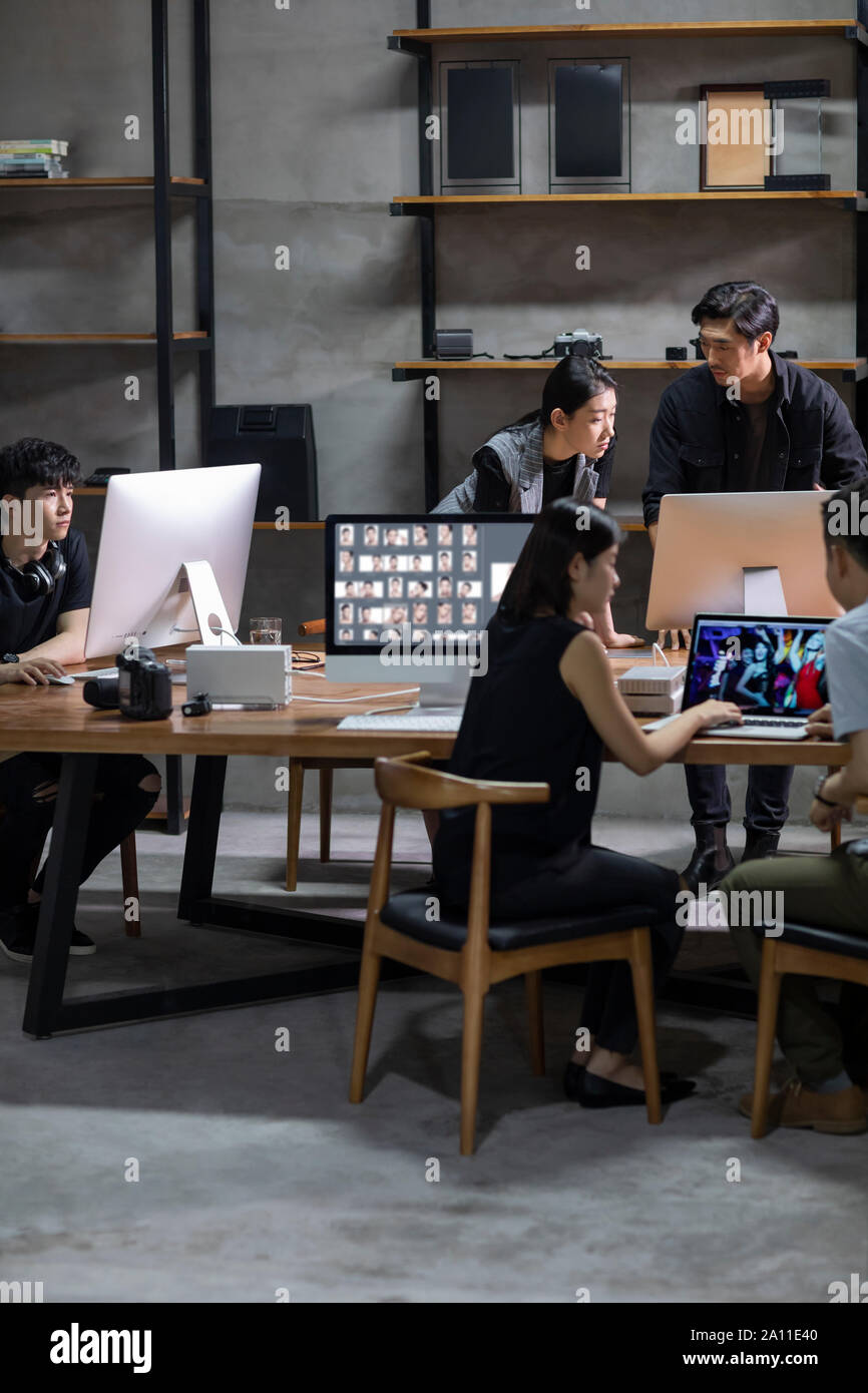 Photographers working in studio Stock Photo - Alamy
