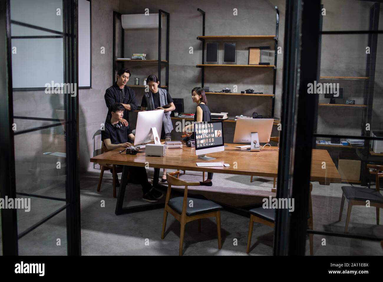 Photographers working in studio Stock Photo - Alamy