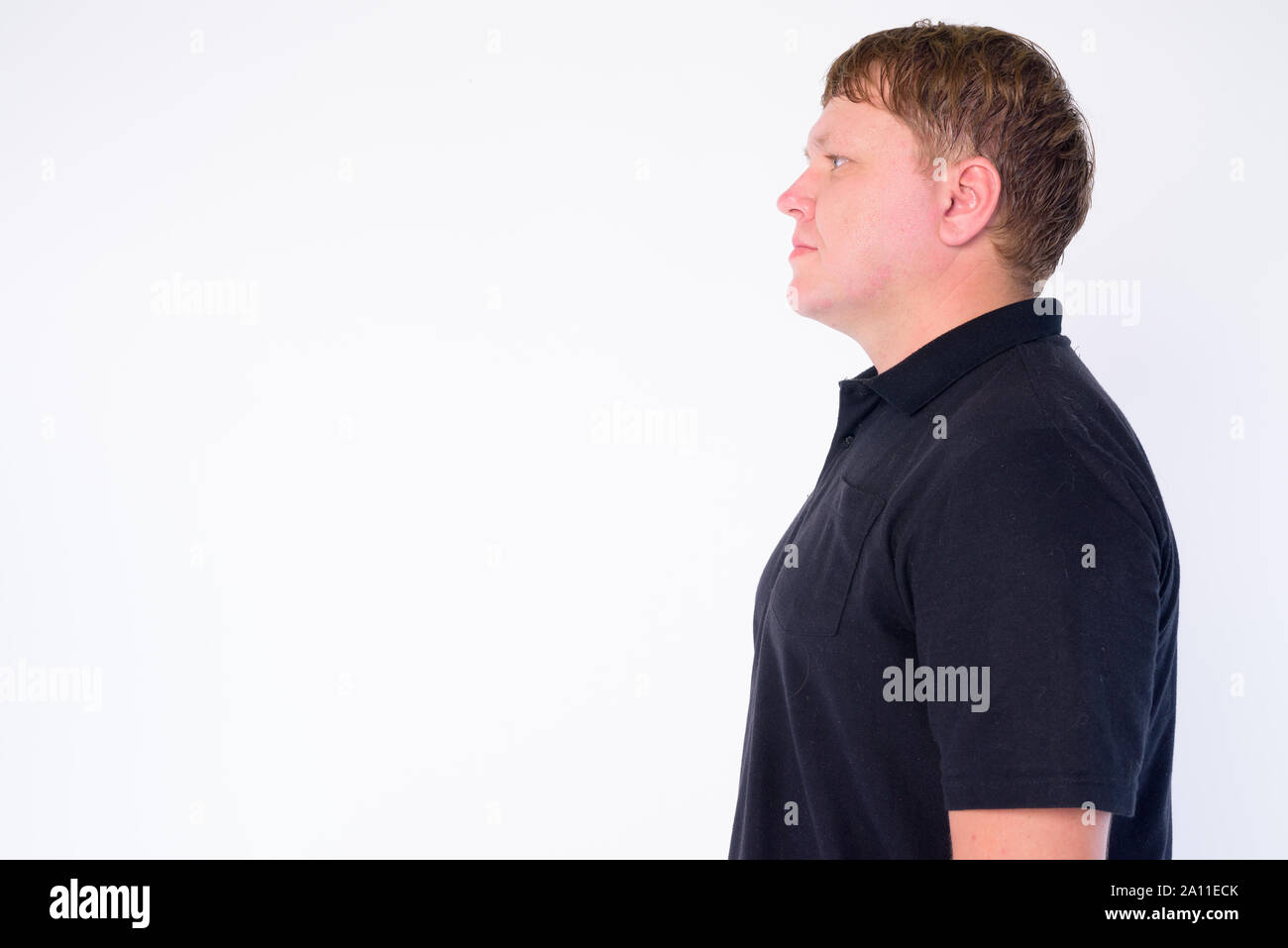 Profile view of overweight man wearing black shirt Stock Photo - Alamy