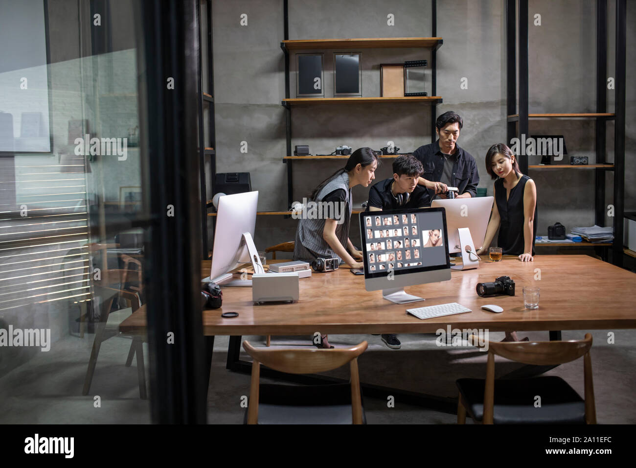 Photographers working in studio Stock Photo - Alamy