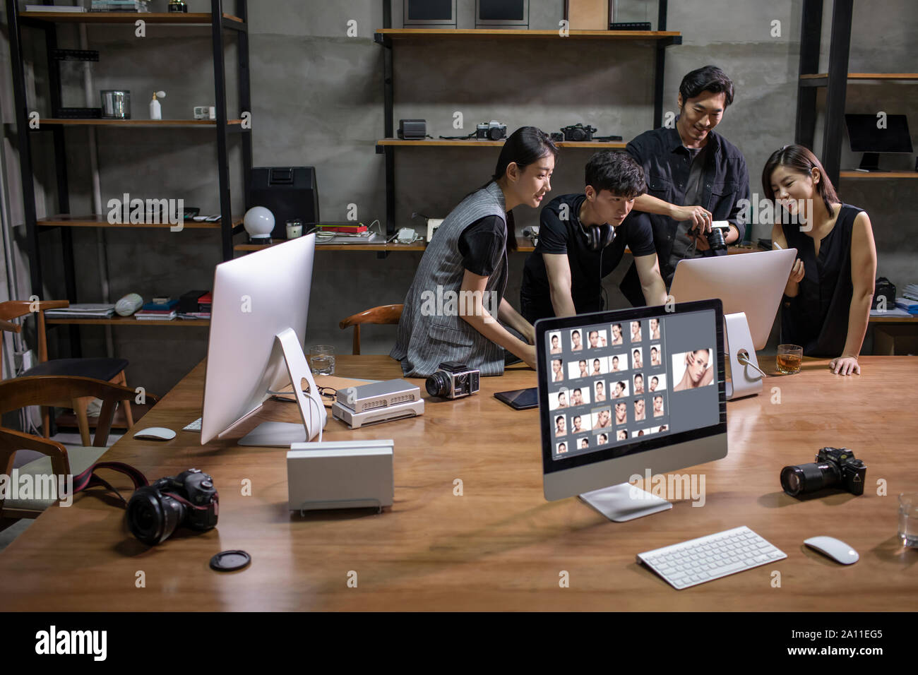 Photographers working in studio Stock Photo - Alamy