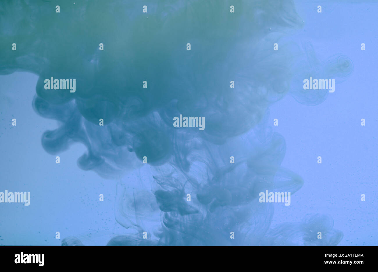 Color drop in water, photographed in motion. Ink swirling. Cloud of ...