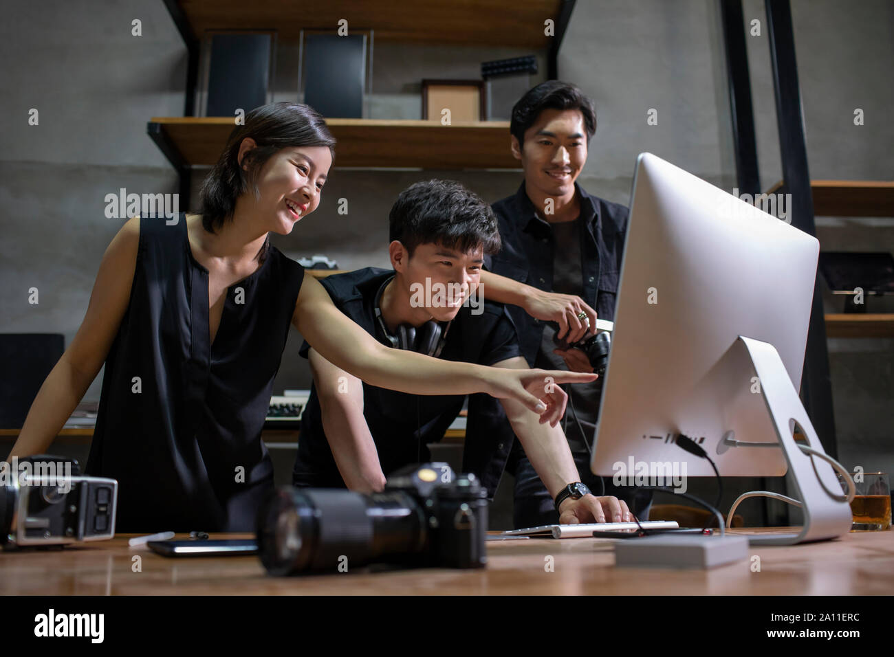 Photographers working in studio Stock Photo - Alamy