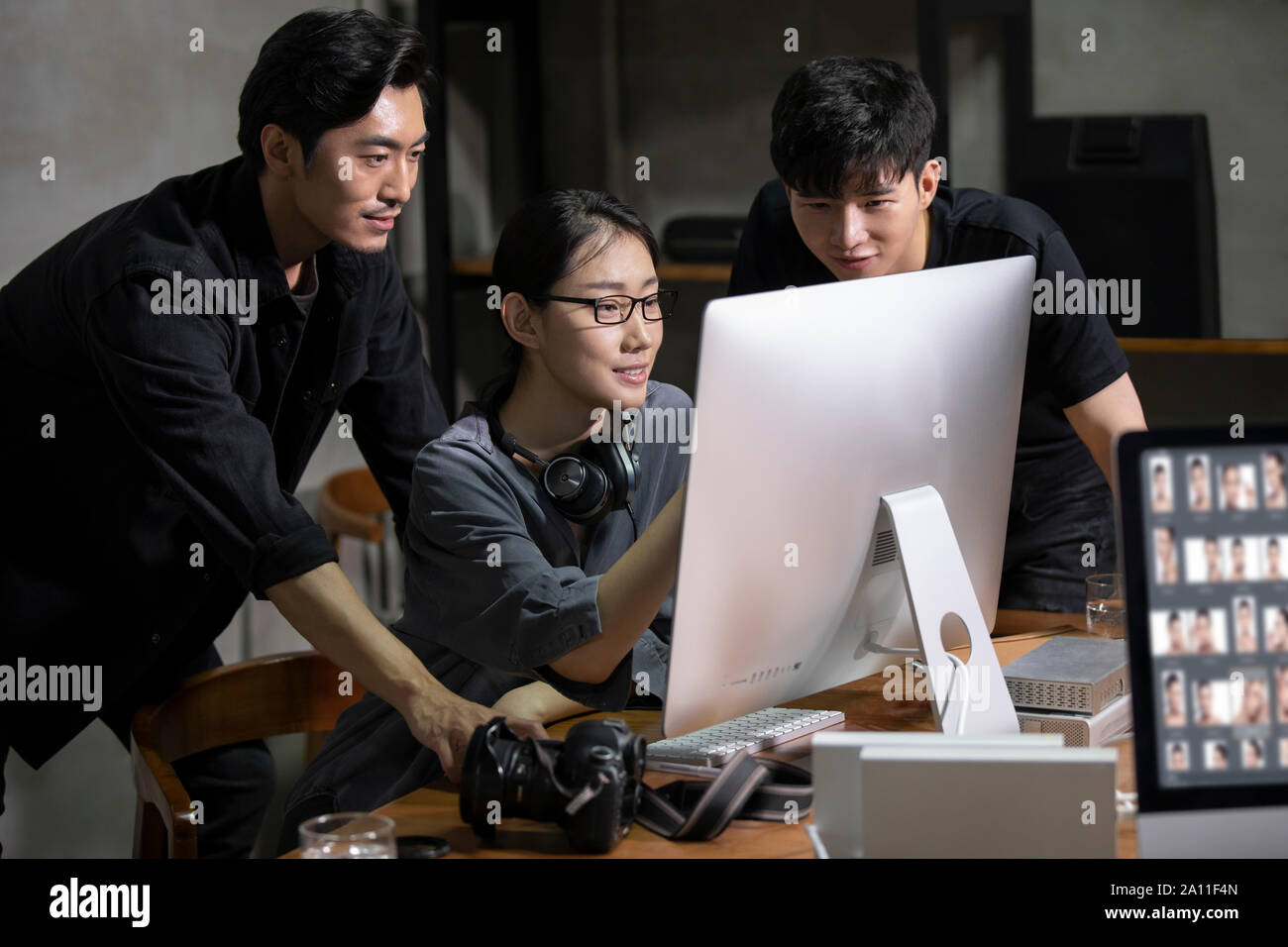 Photographers working in studio Stock Photo - Alamy