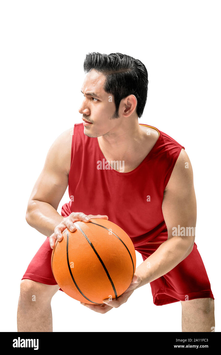 Asian man playing basketball in action posing isolated over white ...