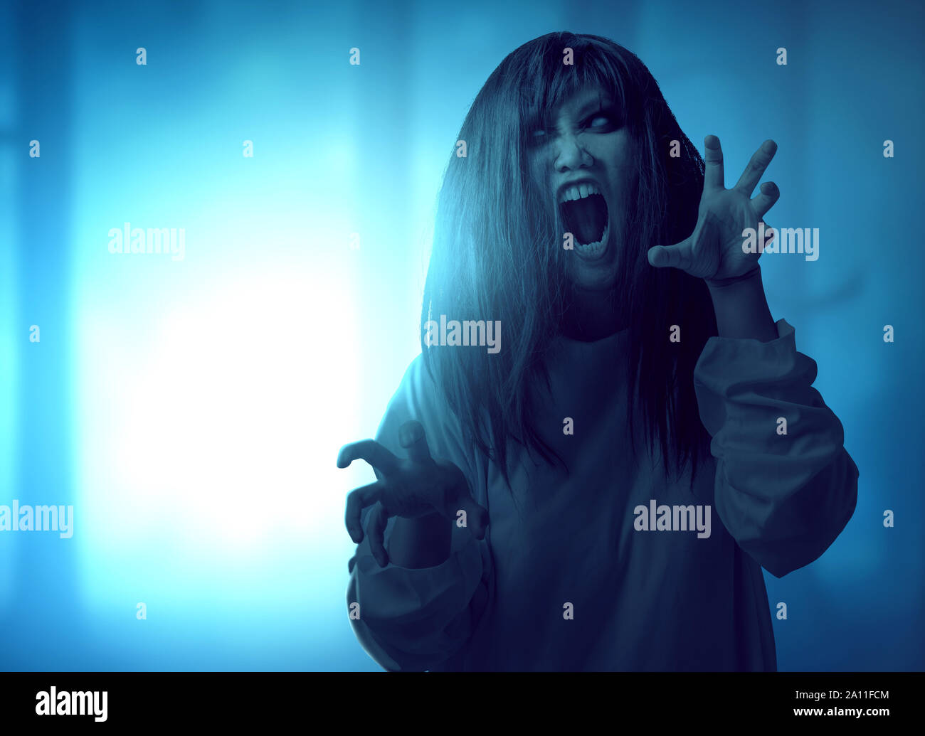 Scary ghost woman with blood and angry face with clawing hands standing ...