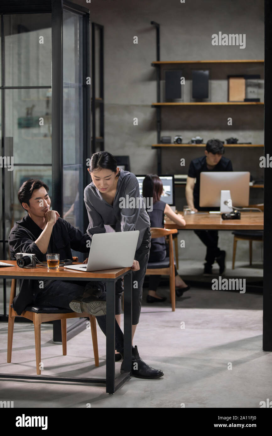 Photographers working in studio Stock Photo - Alamy