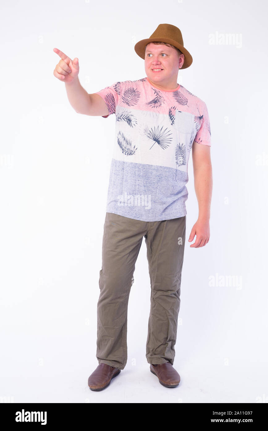 Full body shot of happy overweight tourist man pointing finger Stock ...