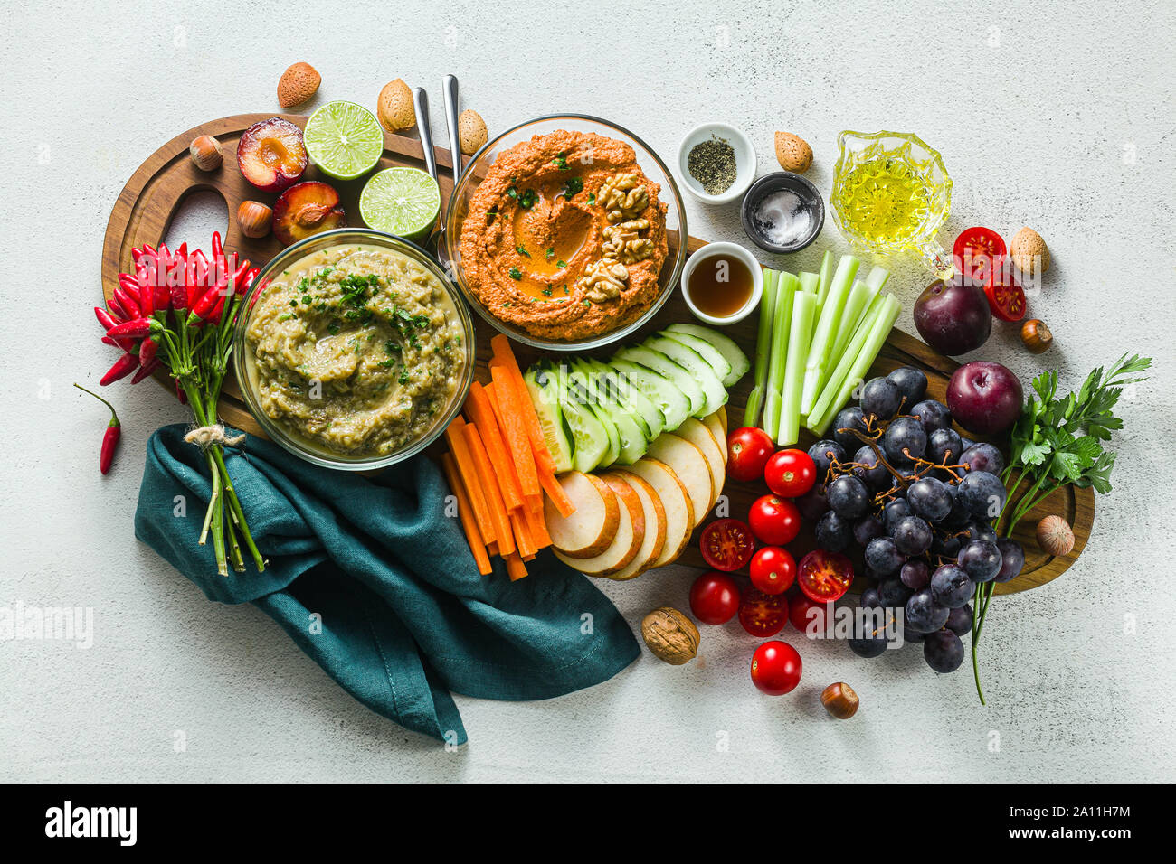 veggie serving table with snacks with vegetables, fruits, baba ganoush ...