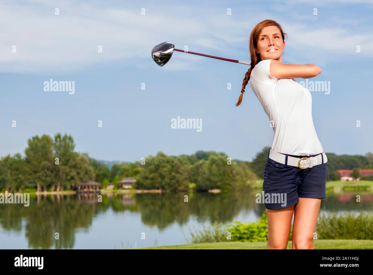 Golf player teeing off Stock Photo - Alamy