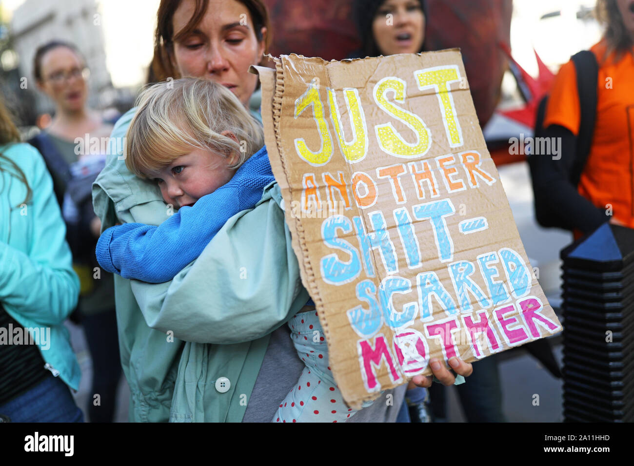 A mother holds her child during a protest organised by Mothers Rise Up ...