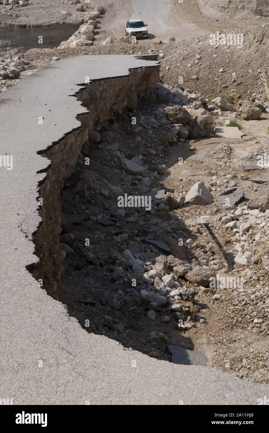 Side of broken asphalt road collapsed and fallen caused by sinkholes ...