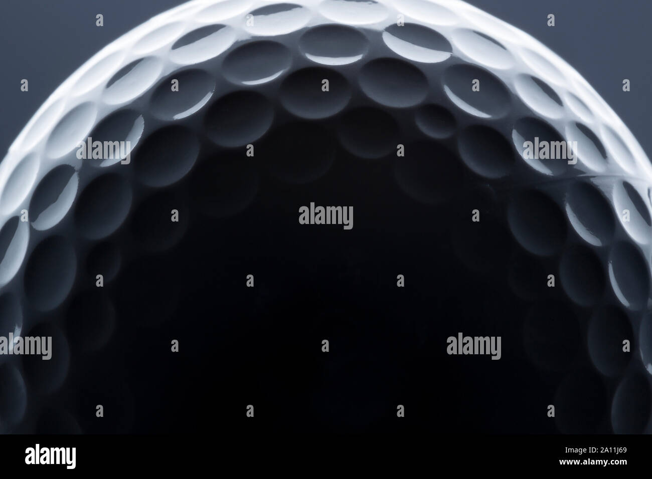 Macro shot of golf ball with light and shadow Stock Photo - Alamy