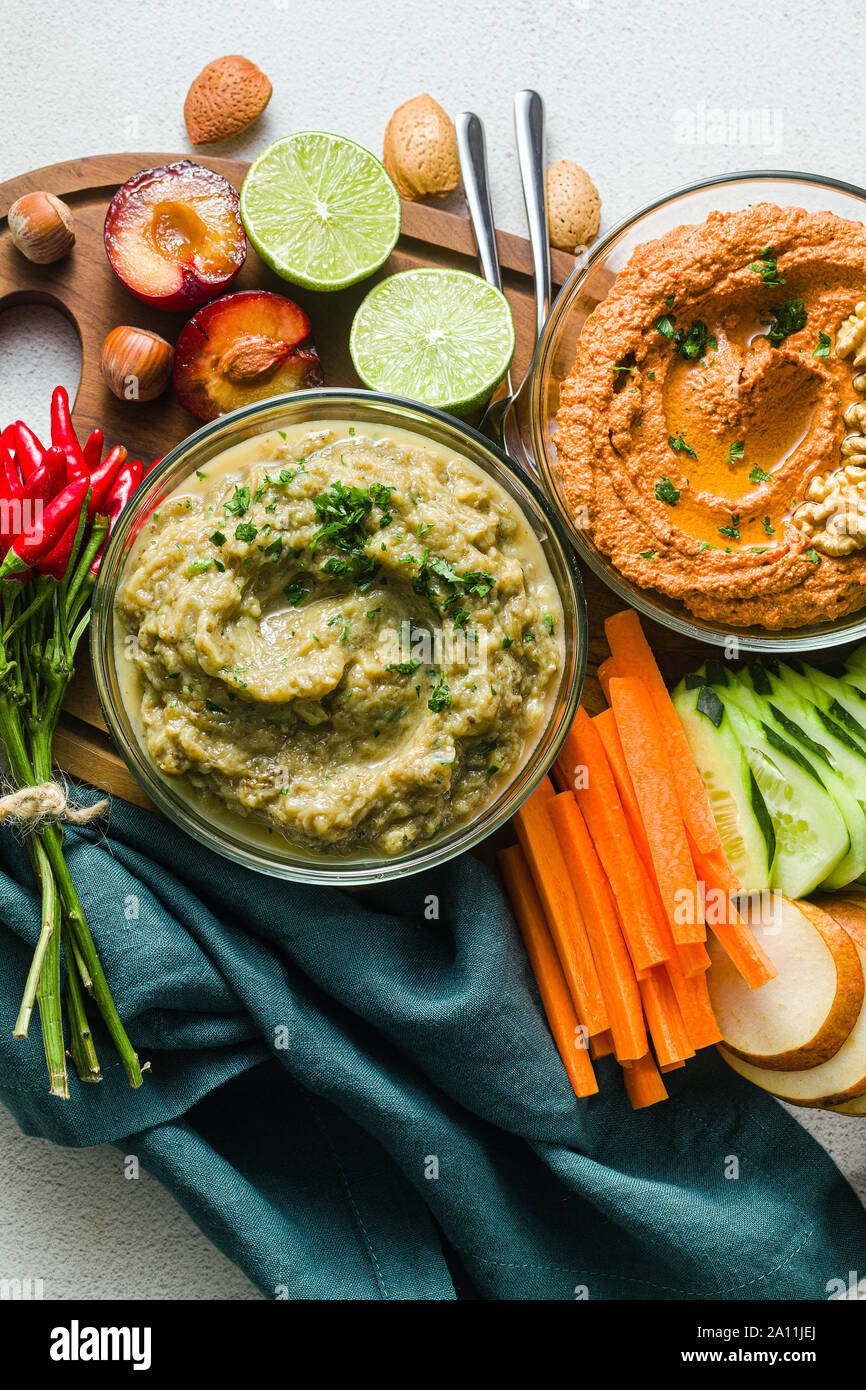 veggie serving table with snacks with vegetables, fruits, baba ganoush ...