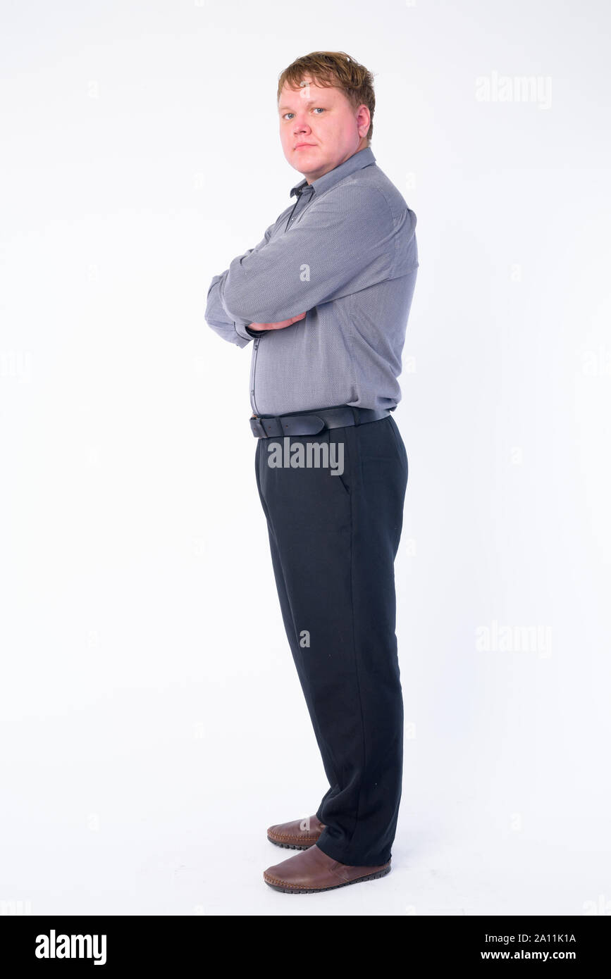 Full body shot profile view of overweight businessman looking at camera ...