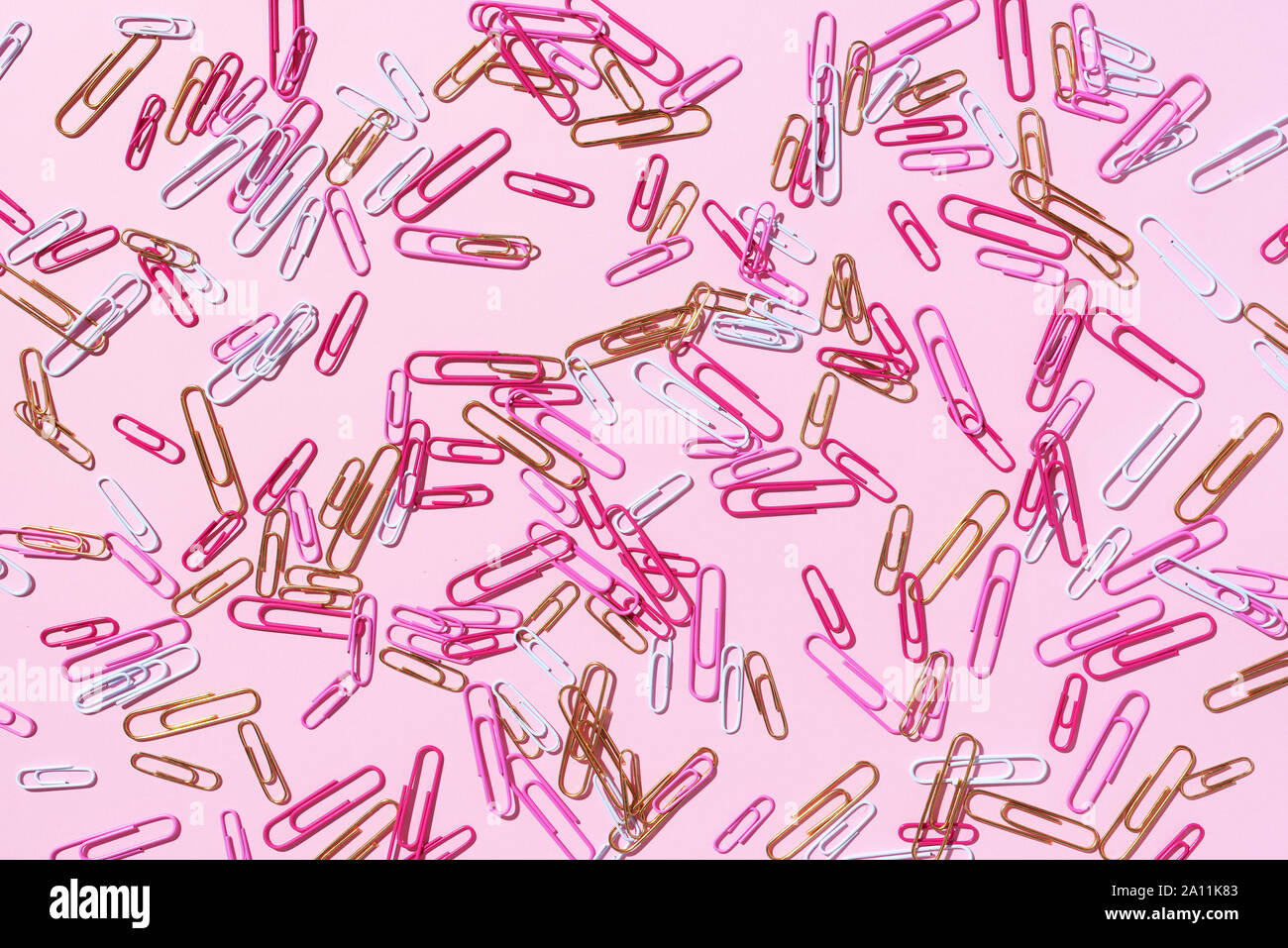 Colored paper clips on pastel pink background. Top view, flat lay. Back ...