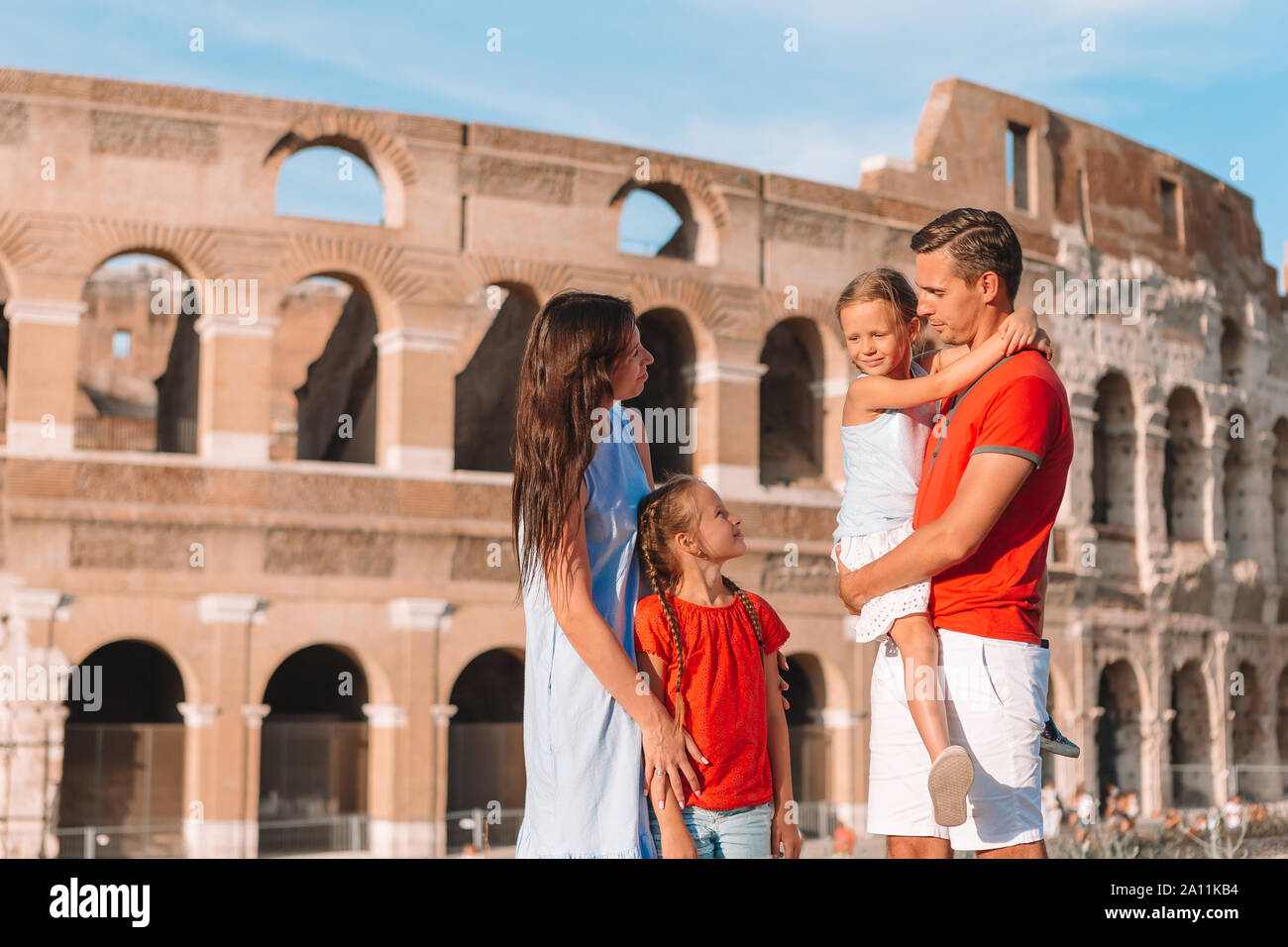 Happy family in Rome over Coliseum background having fun together Stock ...
