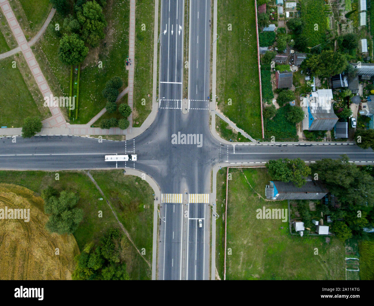 Top view asphalt road, a crossroads in the village on a bright sunny ...