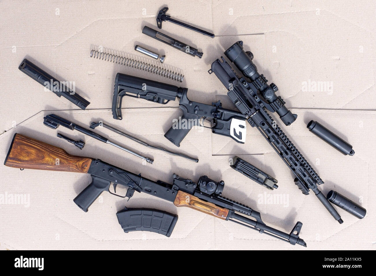 Disassembled AK and AR-15 rifles. Flatley. Concept for shooting school ...