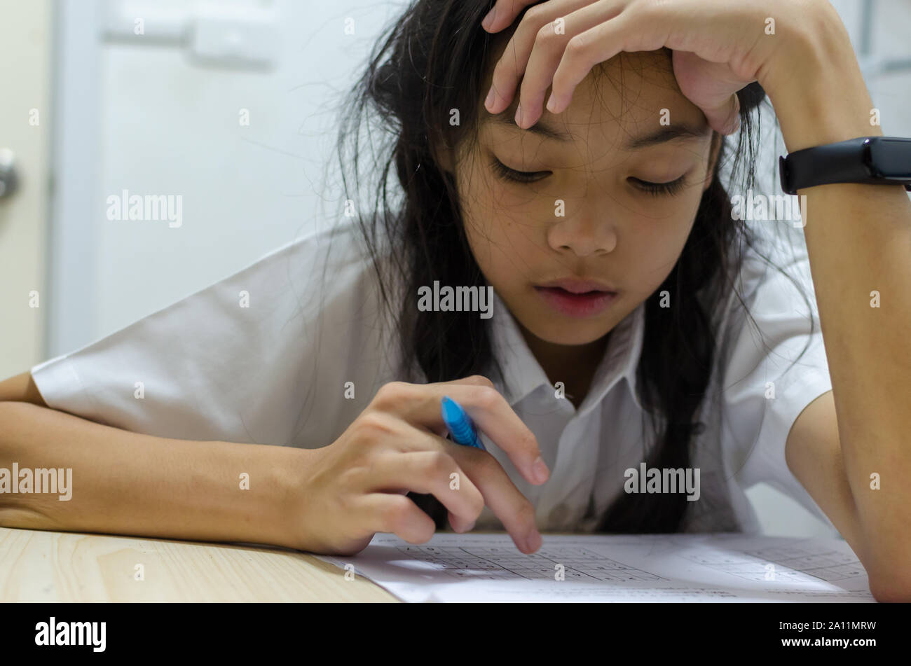 Girl homework desk thinking unhappy hi-res stock photography and images ...