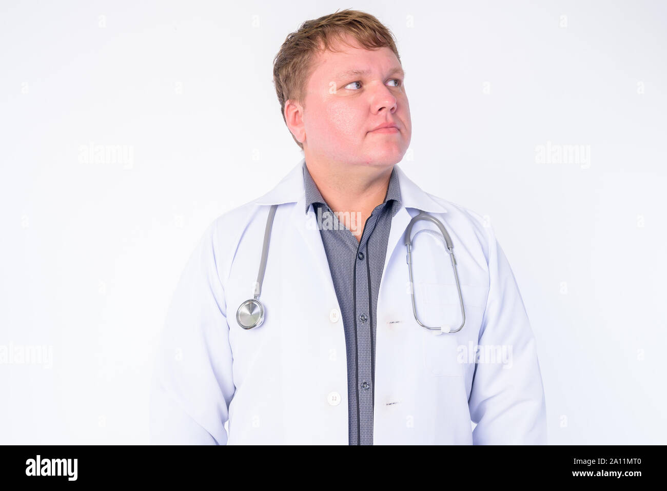 Face of overweight man doctor thinking and looking up Stock Photo - Alamy