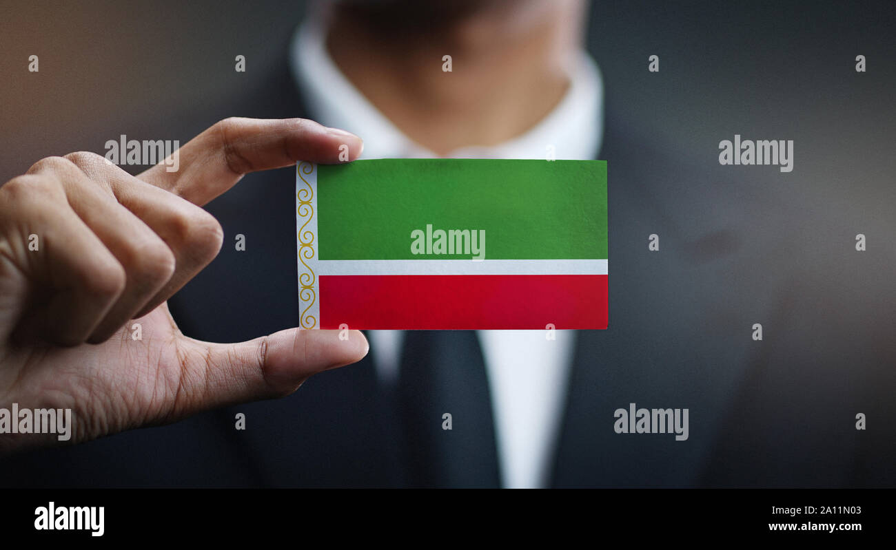 Businessman Holding Card of Chechen Republic Flag Stock Photo - Alamy