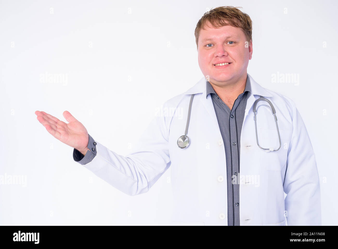 Portrait of happy overweight man doctor showing something Stock Photo ...