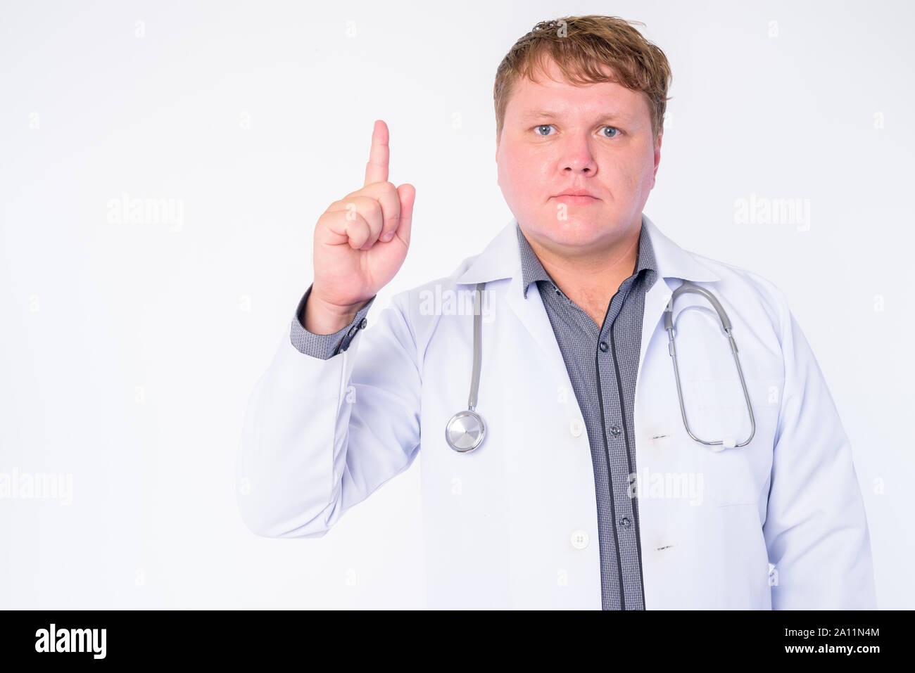Portrait of overweight man doctor pointing up Stock Photo - Alamy