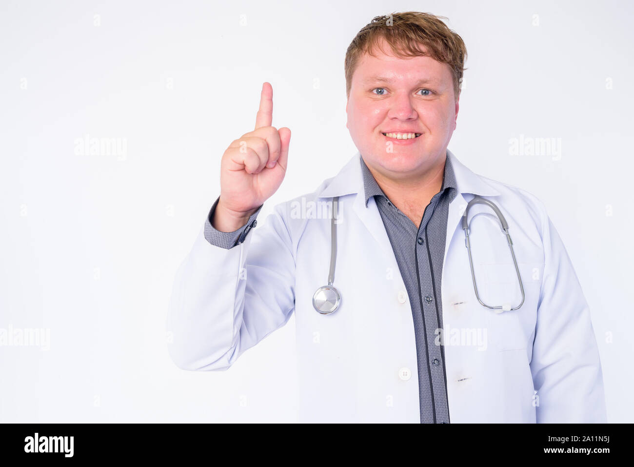Portrait of happy overweight man doctor pointing up Stock Photo - Alamy