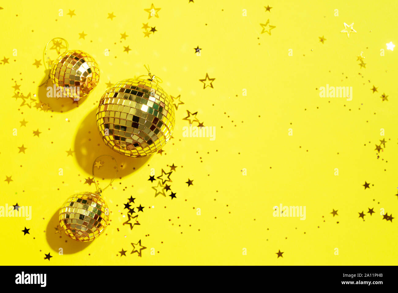 Creative Christmas concept. Shiny gold disco balls over yellow ...