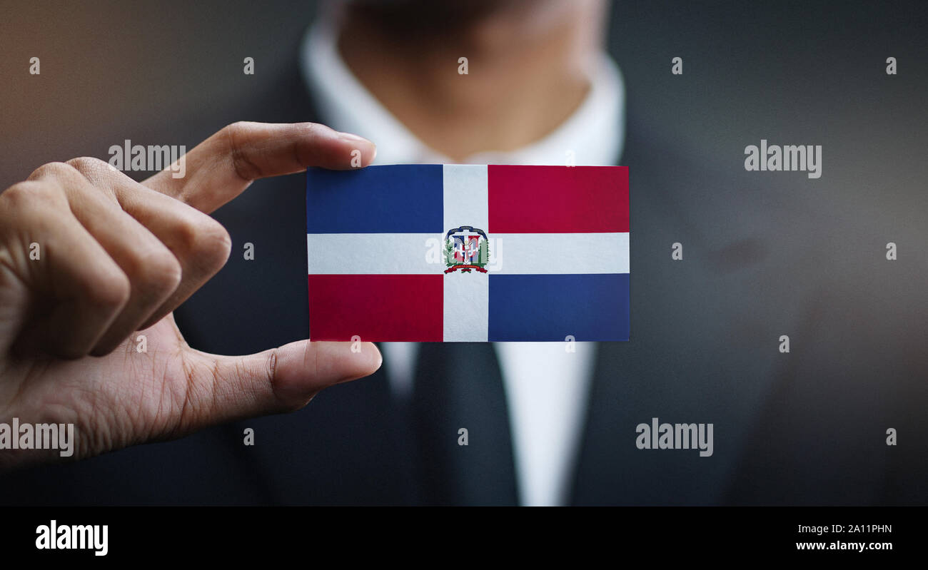 Businessman Holding Card of Dominican Republic Flag Stock Photo - Alamy