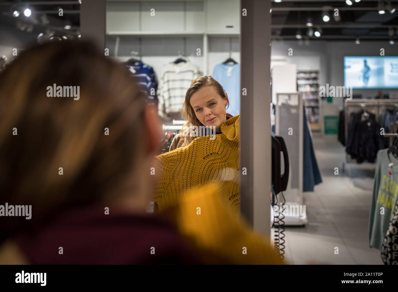 Young woman shipping in a clothing store for something fashionable ...