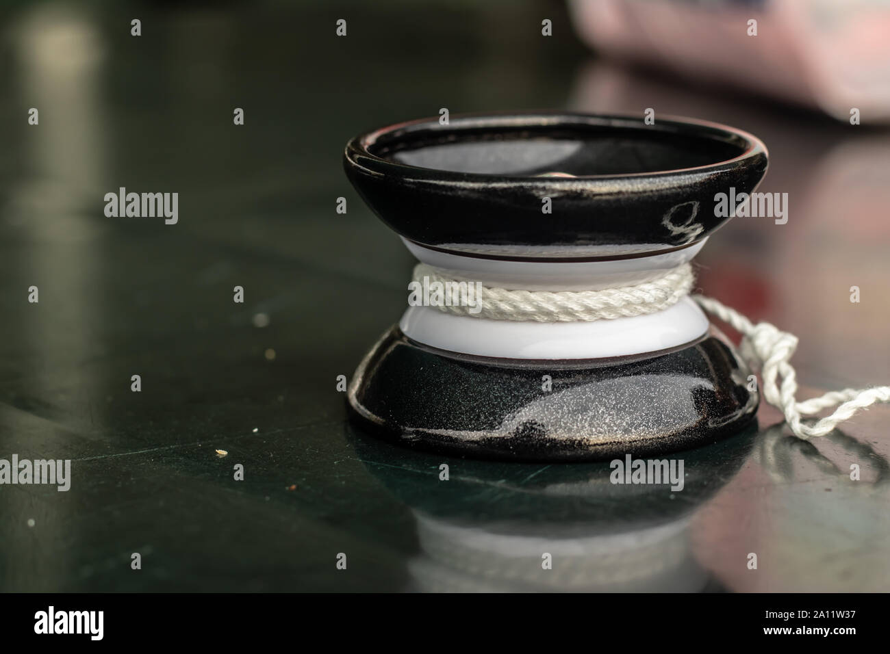 a closeup shoot from black yo-yo - there is green table under it and ...
