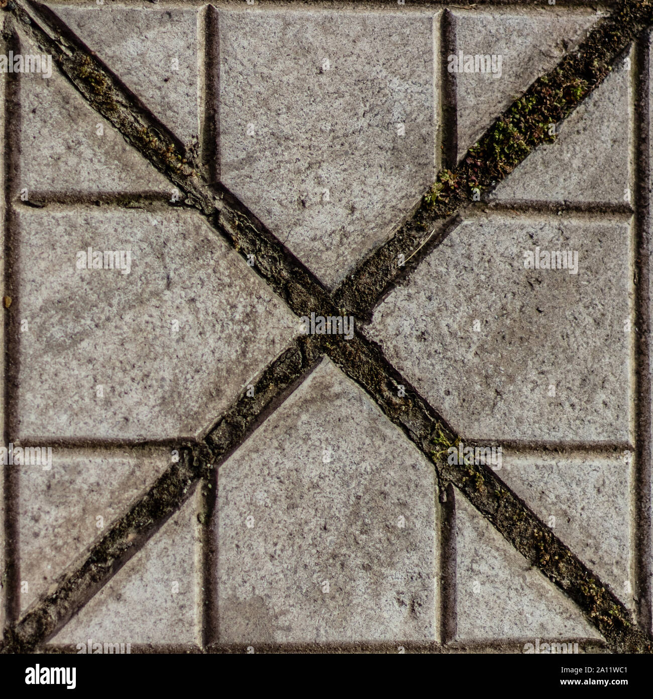 an old square shape from a pavement - gray colored stone pavement. a ...