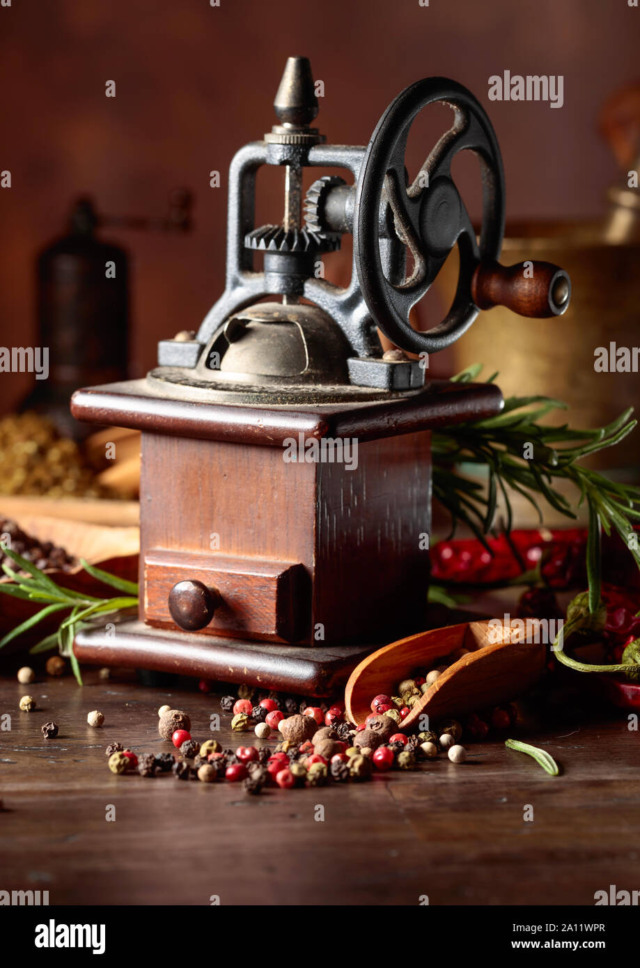 Vintage pepper mill with various peppers and spices. Old pepper mill ...