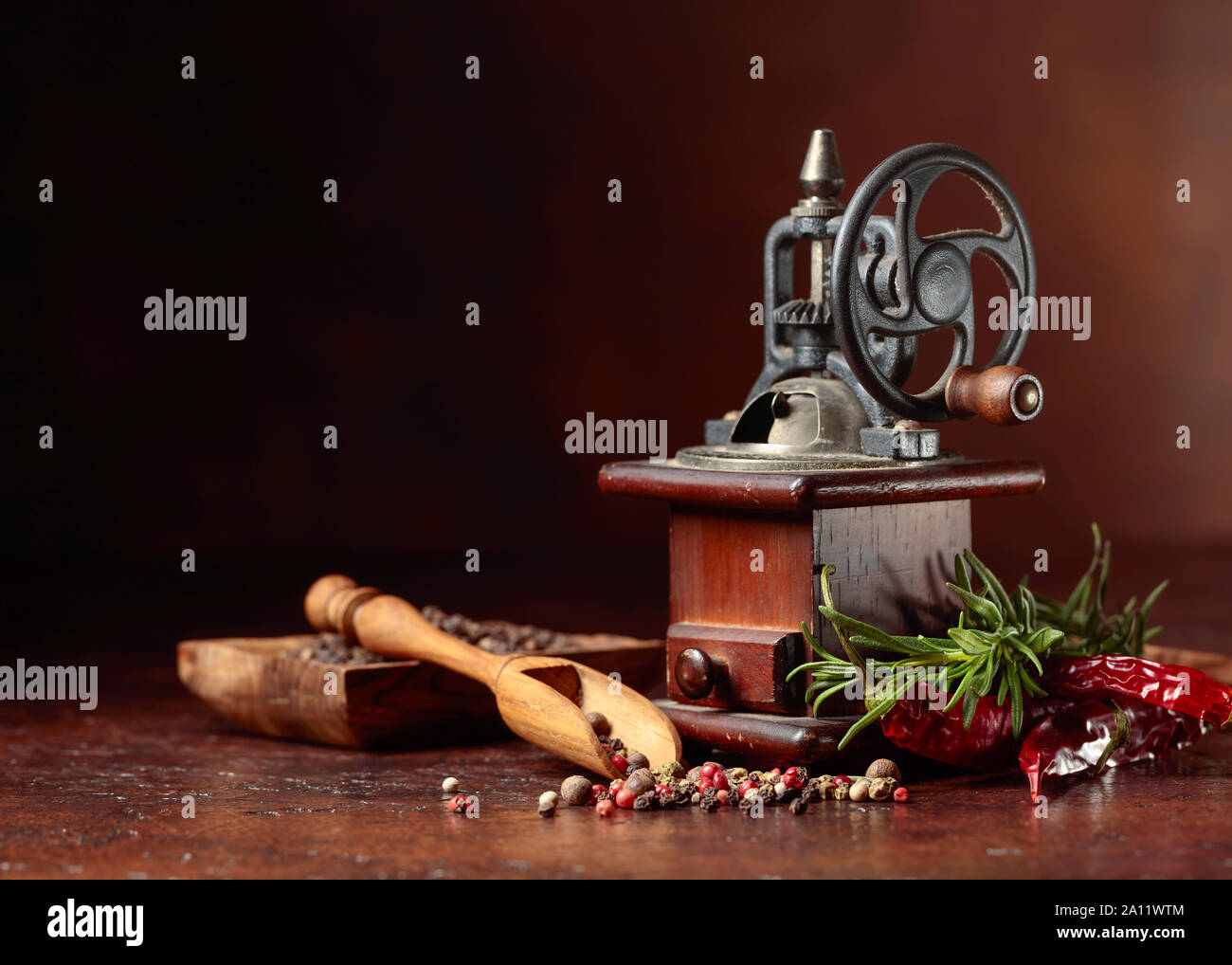 Vintage pepper mill with various peppers and spices. Old pepper mill ...