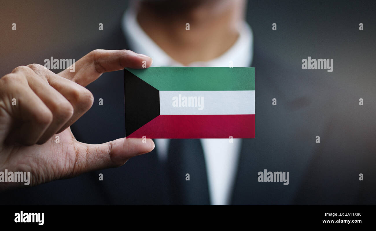 Businessman Holding Card of Kuwait Flag Stock Photo - Alamy
