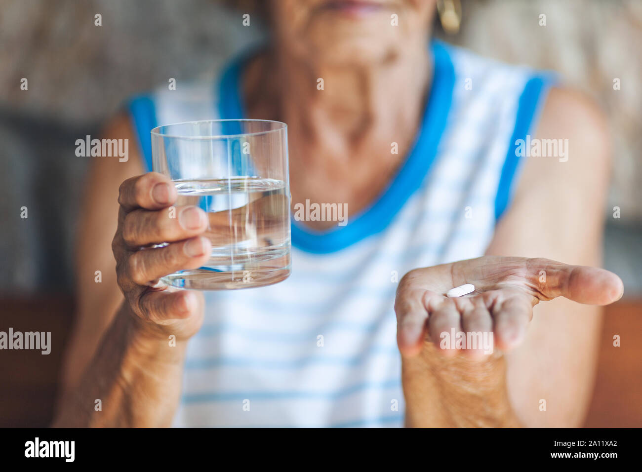 Senior person taking tablets hi-res stock photography and images - Alamy