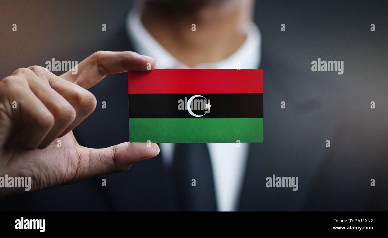 Businessman Holding Card of Libya Flag Stock Photo - Alamy