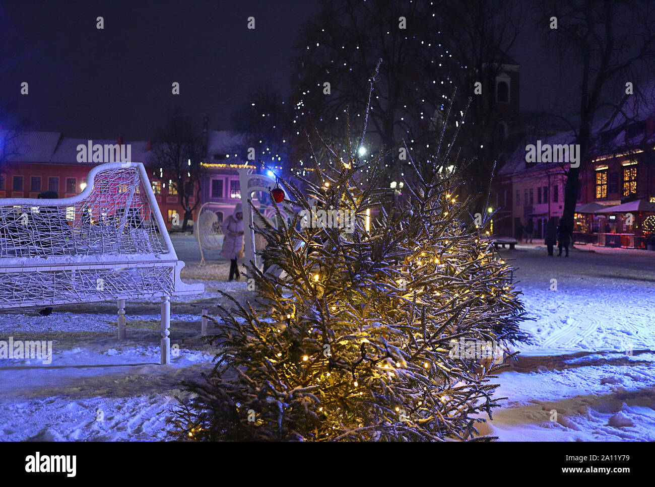 Christmas tree, holiday decoration, illumination and falling snow ...